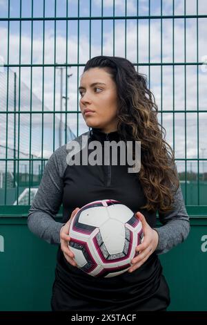 young woman holding soccer ball on her hand Stock Photo - Alamy
