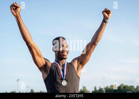 Portrait of athlete celebrating with medal Stock Photo - Alamy