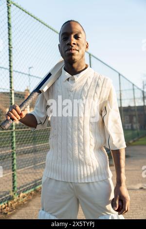 Portrait of cricketer standing on outdoors sports court Stock Photo - Alamy