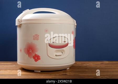 side view electric rice cooker on red at vertical composition Stock ...