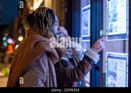 Two men looking at window display Stock Photo - Alamy