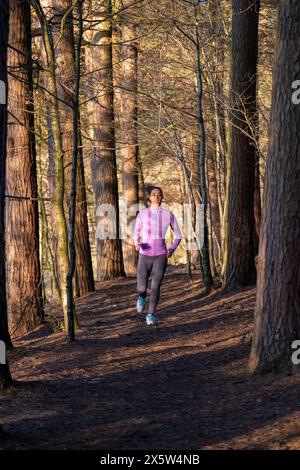 woman jogging in forest Stock Photo - Alamy