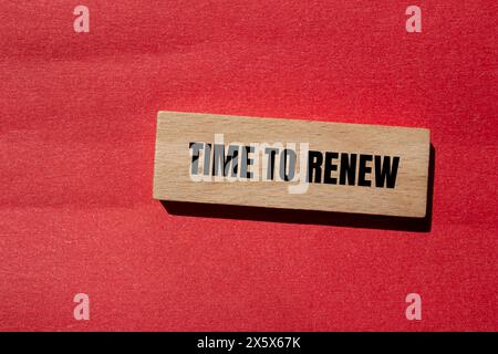 Time to renew words written on wooden blocks with pink background ...