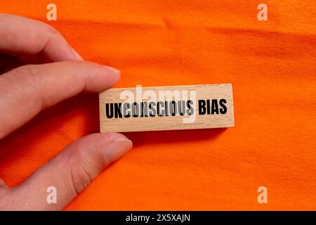 Unconscious bias words written on ripped paper with green background. Conceptual unconscious ...