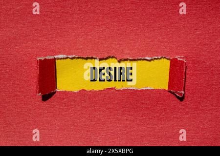 Desire word written on ripped yellow paper with blue background Stock ...
