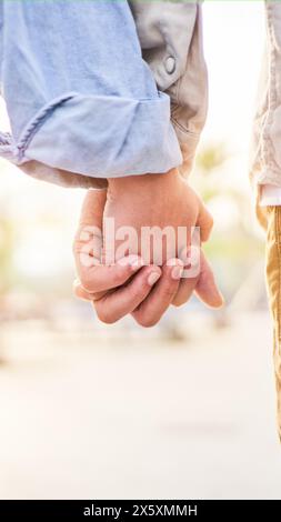 Close-up of unrecognizable people holding small American flags on ...