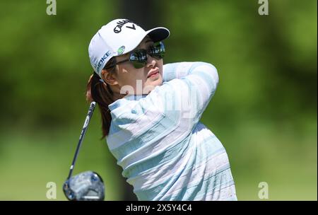 Yan Liu of China watches her tee shot on the first hole during the ...