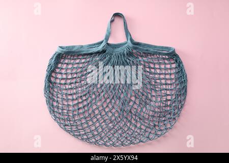 Blue string bag on pink background, top view. Space for text Stock ...