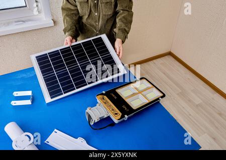 Assembling LED street lighting with solar panel, owner prepares ...