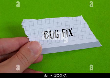 Bug fix words written on wooden block with orange background ...