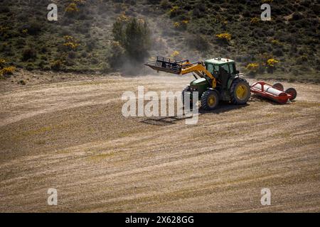 tractor in the field plowing and flattening the land for sowing Stock ...