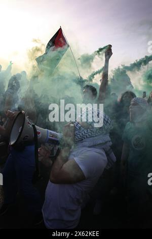 A Pro-Palestinian protester chants through a megaphone during the ...