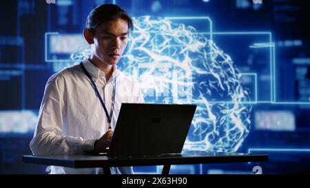 Admin using laptop to visualize artificial intelligence neural networks made up of ...