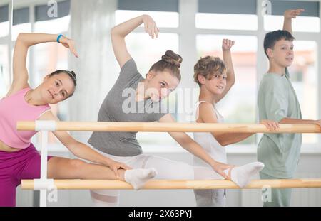 Ballet pose grand batman - girls and boys at a choreography lesson are ...