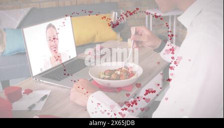 Caucasian couple enjoying virtual dinner date, boyfriend holding wine ...