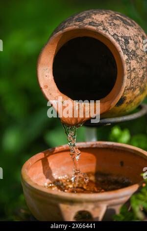 Pottery solar powered garden water feature UK Stock Photo - Alamy