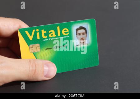 Young man's health insurance card of the national health care system in ...