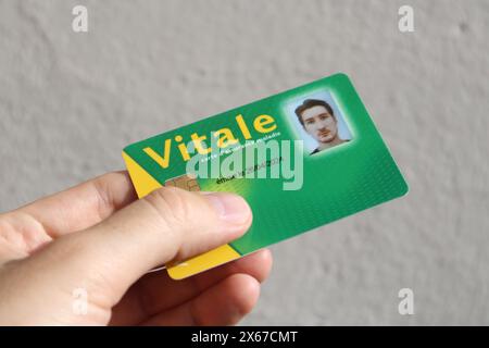 Young man's health insurance card of the national health care system in ...