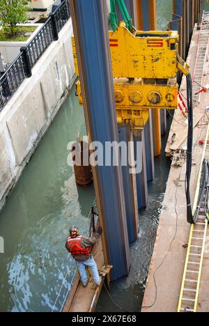 Worker on riverside construction Stock Photo - Alamy