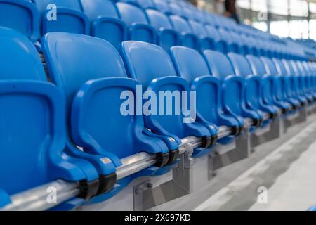 A long row of modern blue chairs with folding seats in a room Stock ...