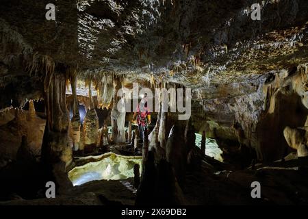 Cave explorers in the forest of stalagmites and stalactites Stock Photo ...