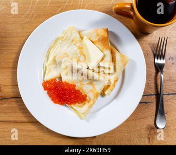 Pancakes with red caviar - famous Russian food Stock Photo - Alamy