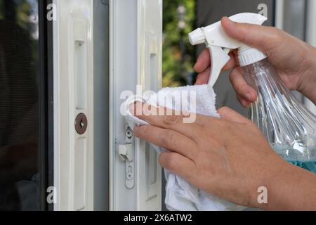 Worker use a soft cloth cleaning uPVC aluminum window frames remove a ...