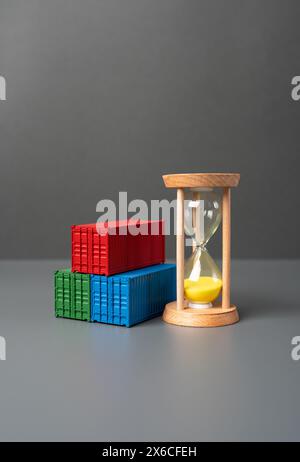Shipping containers and hourglass. Freight and shipping costs. Delivery ...