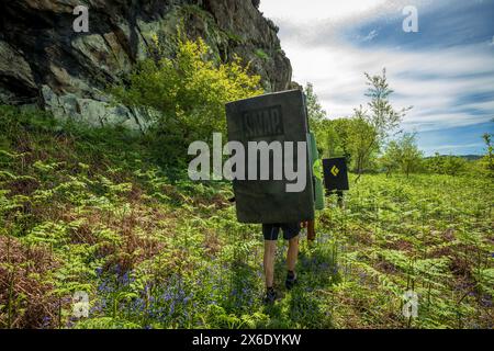 Climbers yomping on a bouldering expedition in North Wales carrying ...