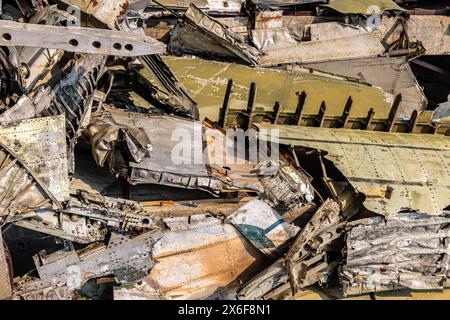 A pile of steel parts from the fuselage and wings of a damaged aircraft ...