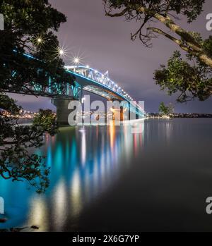 Auckland Harbour Bridge glowing in blue. Auckland, New Zealand Stock ...