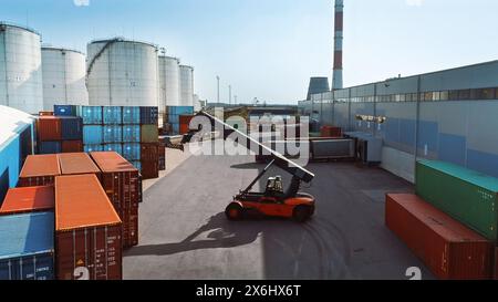 Aerial Shot of a Container Handler Carrying a Large Red Shipping Cargo ...
