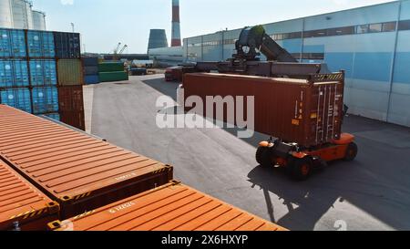 Aerial Shot of a Container Handler Carrying a Large Red Shipping Cargo ...