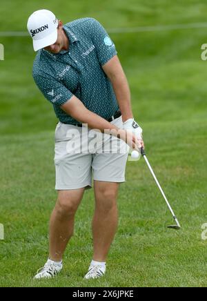 Sepp Straka, of Austria, chips onto the first green during a practice ...