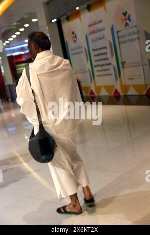 Pilgrims wearing Ihram Clothing en route to Jeddah for hajj at Muscat ...