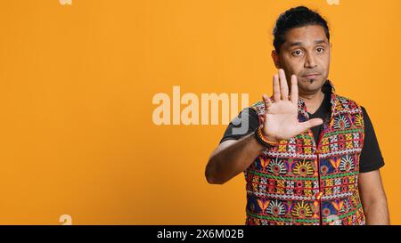 Stern indian man doing stop hand gesture sign, complaining ...