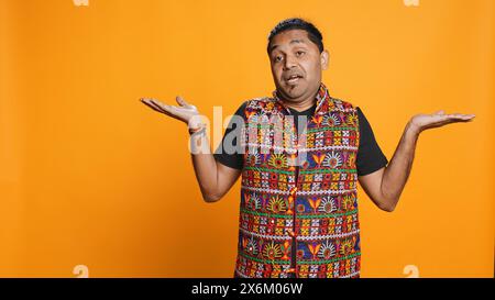 Indian man shrugging shoulders, unable to provide answer, having ...