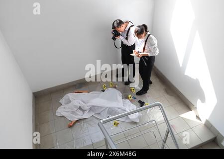 FBI agents working at crime scene with dead body Stock Photo - Alamy