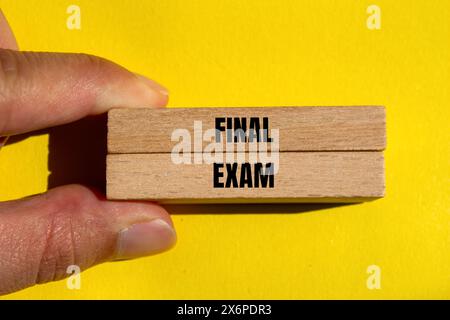 Final exam words written on ripped red paper with brown background ...