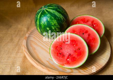 Two watermelons, one of them cut in slices. Still life Stock Photo - Alamy