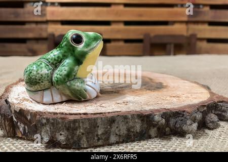 Green frog on the wood. Fake frog Stock Photo - Alamy