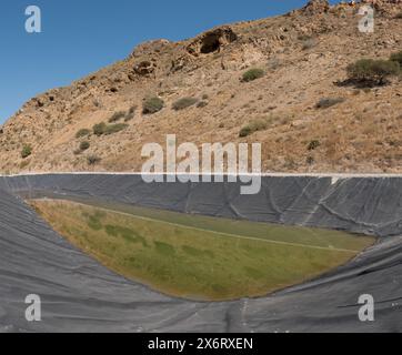 Empty irrigation lined pond, water reservoir in Spain, lack of rain a ...