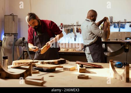 Artisan applying varnish on wood object to build up protective layer ...
