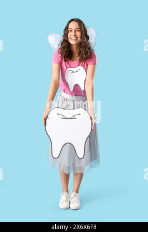 Tooth Fairy with paper figure on blue background Stock Photo - Alamy