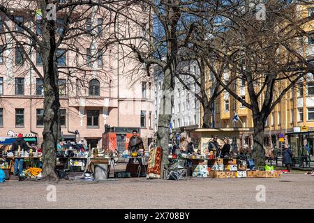 People and secondhand goods at outdoor swap meet held in Karhupuisto in ...