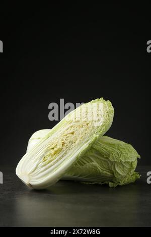 Whole and cut fresh Chinese cabbages on grey table Stock Photo - Alamy