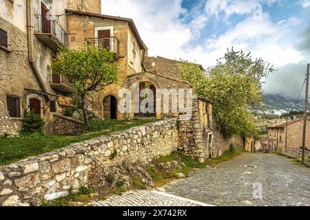 Glimpse of the stone buildings and the access gate to a courtyard of a ...