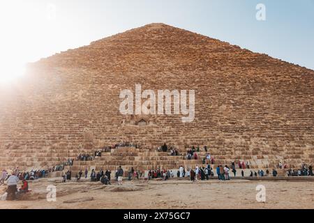 Tourists gather at the base of the Great Pyramid of Giza, Egypt ...