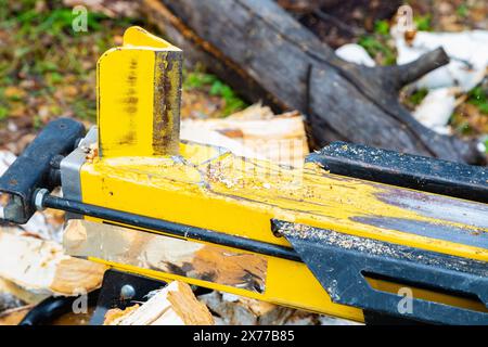 Mechanical action of a wood splitter with destructive force on a birch ...