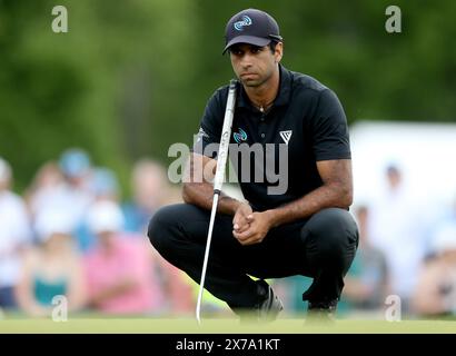 Aaron Rai, of England, lines up a putt on the 17th green during the ...